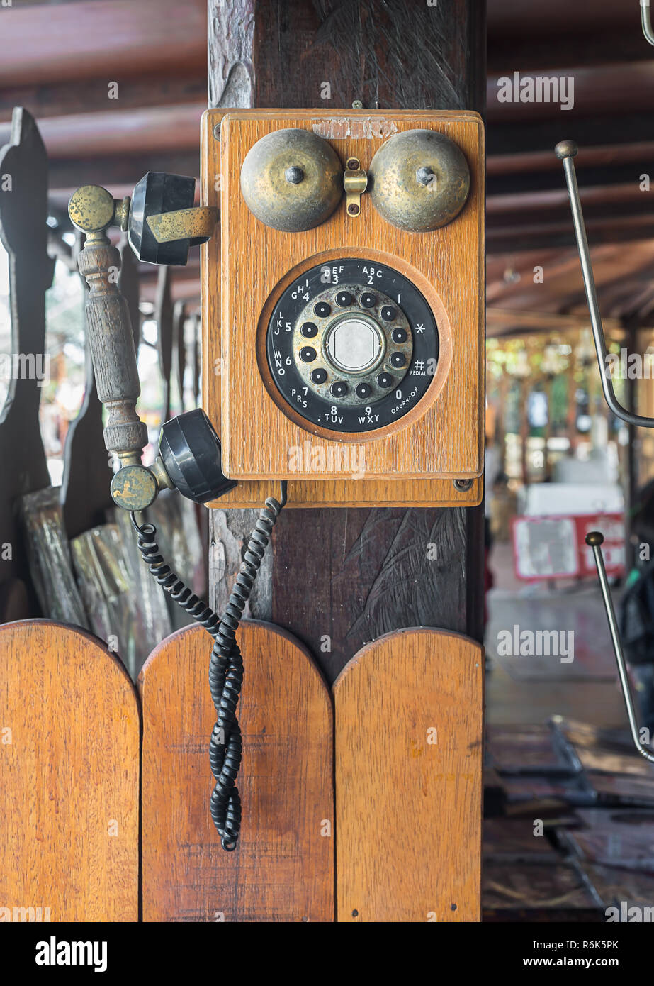 Vintage telephone hang on wooden pole Stock Photo - Alamy