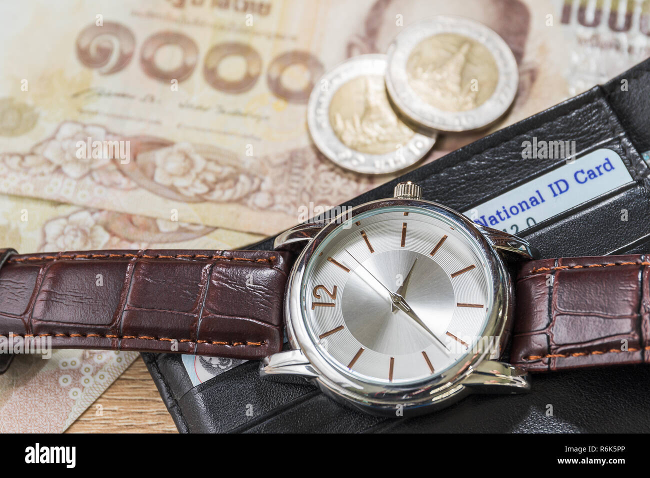 Watch and wallet on banknote Stock Photo - Alamy