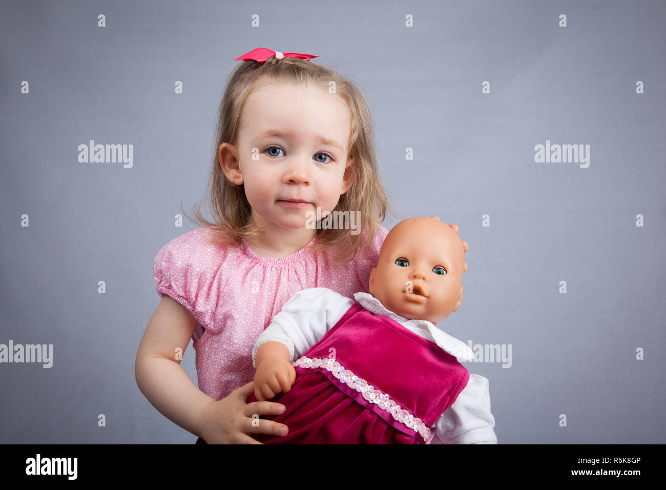 Girl with doll Stock Photo - Alamy