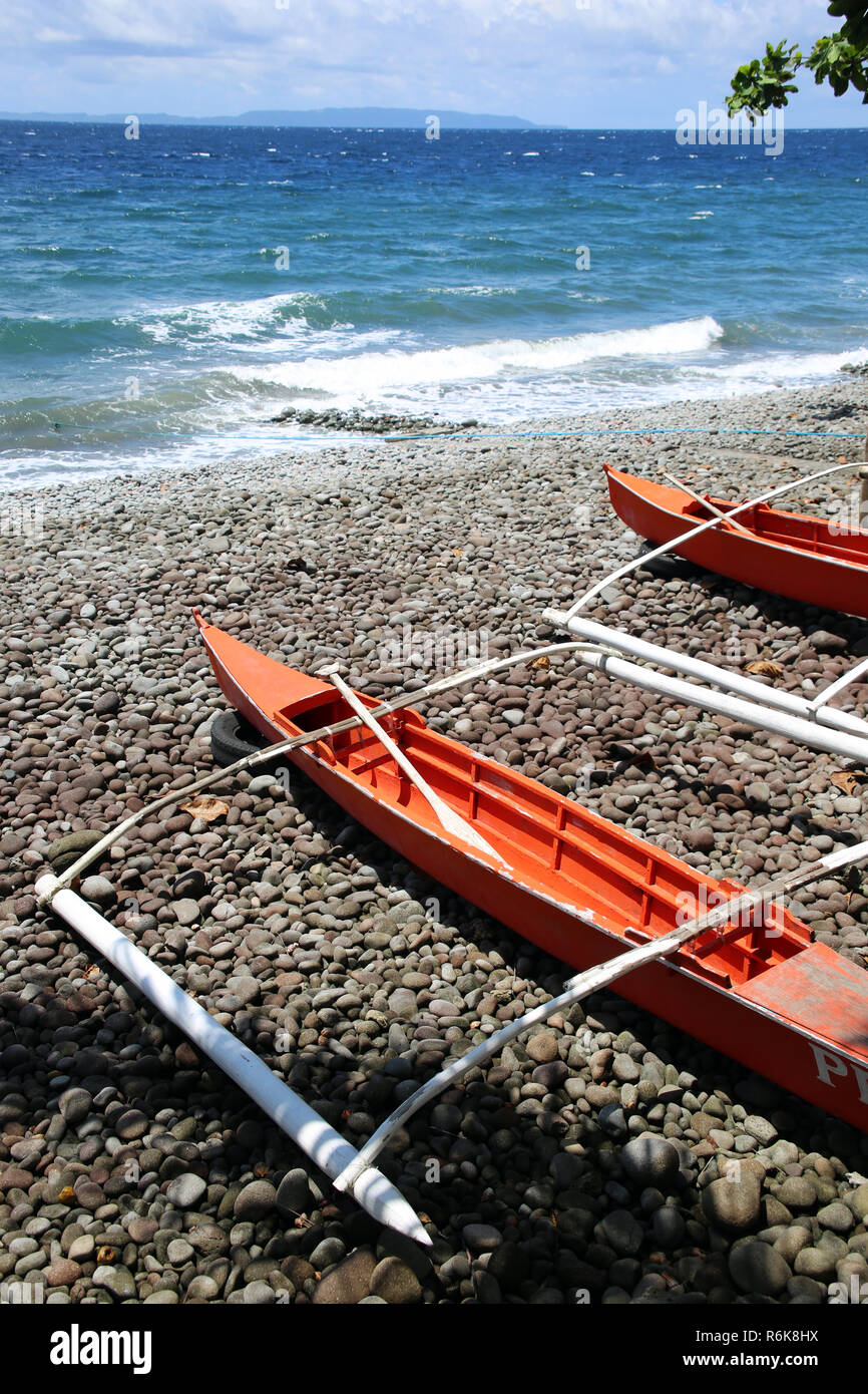 fishing boat on the pebble beach Stock Photo - Alamy