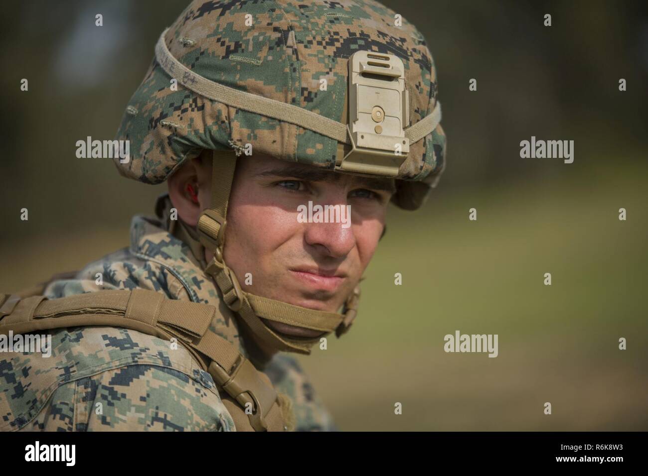 Lance Cpl. Colton Rine listens to range directions before firing, May ...
