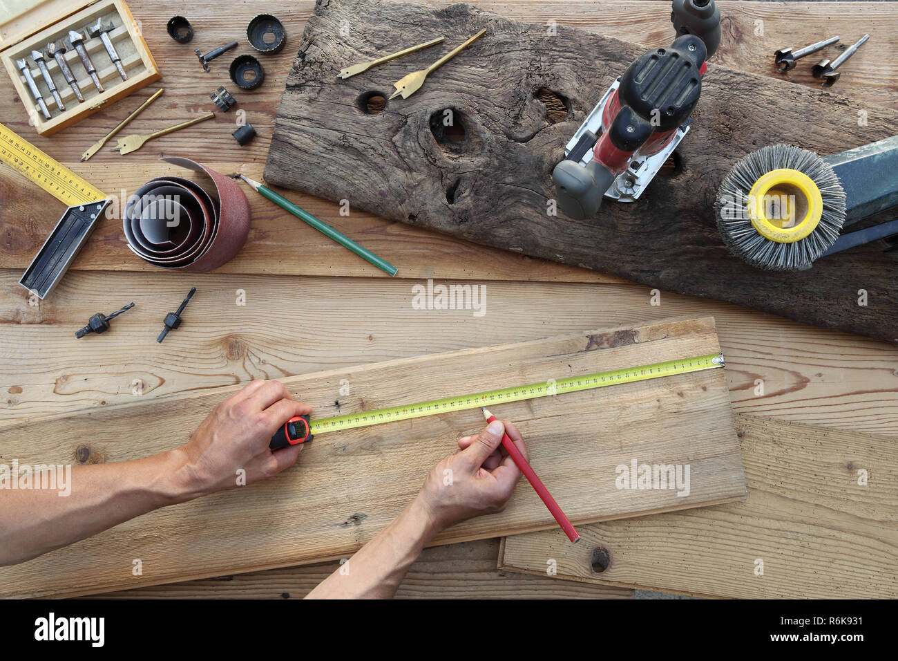 hands carpenter work the wood, measuring with tape meter and pencil old ...