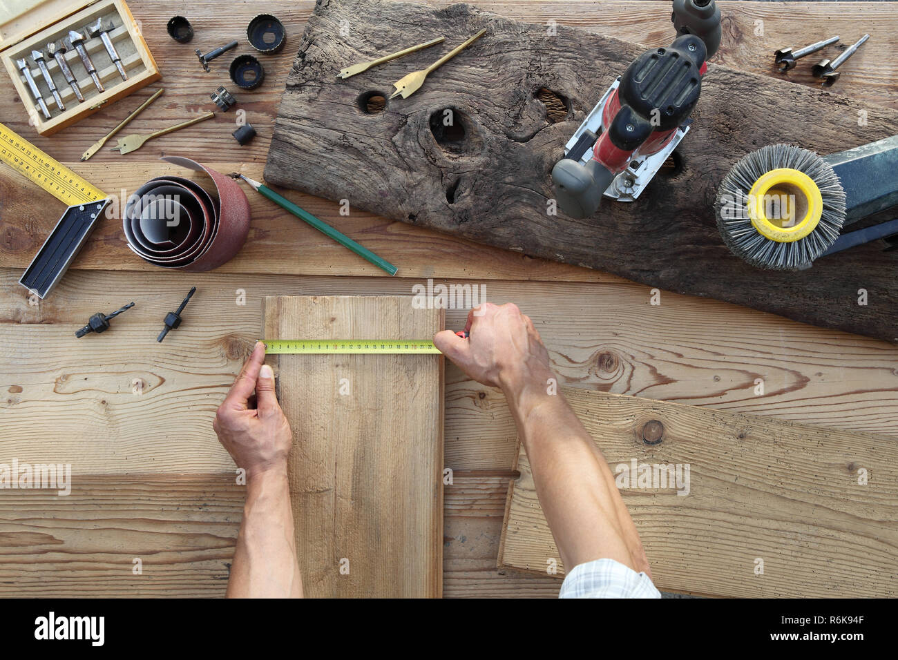 hands carpenter work the wood, measuring with tape meter old rustic ...