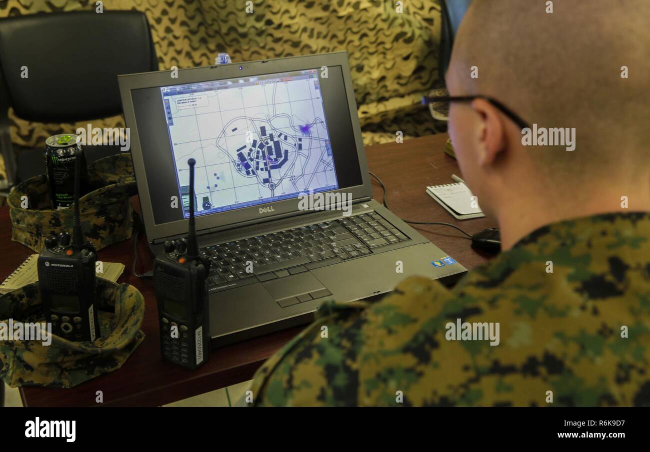 A Marine looks at a computer displaying the positions of both teams ...