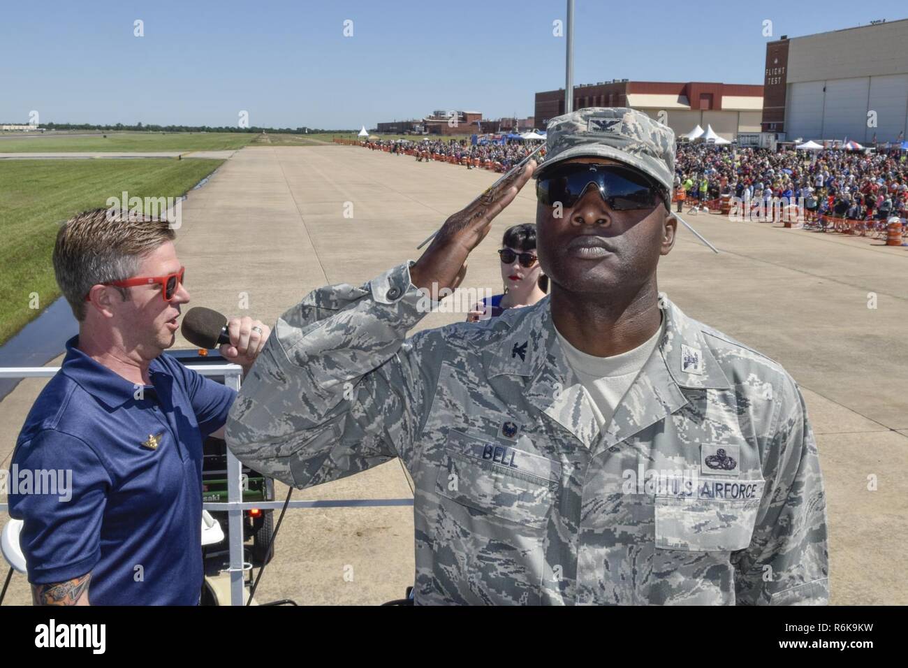 Col. Kenyon Bell, 72nd Air Base Wing commander, salutes as John Eads ...