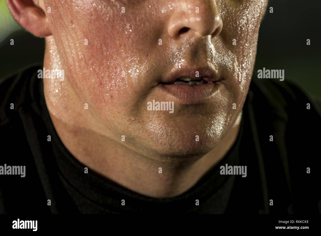 Sweat drips down the face of a U.S. Army Reserve Soldier from the 200th ...