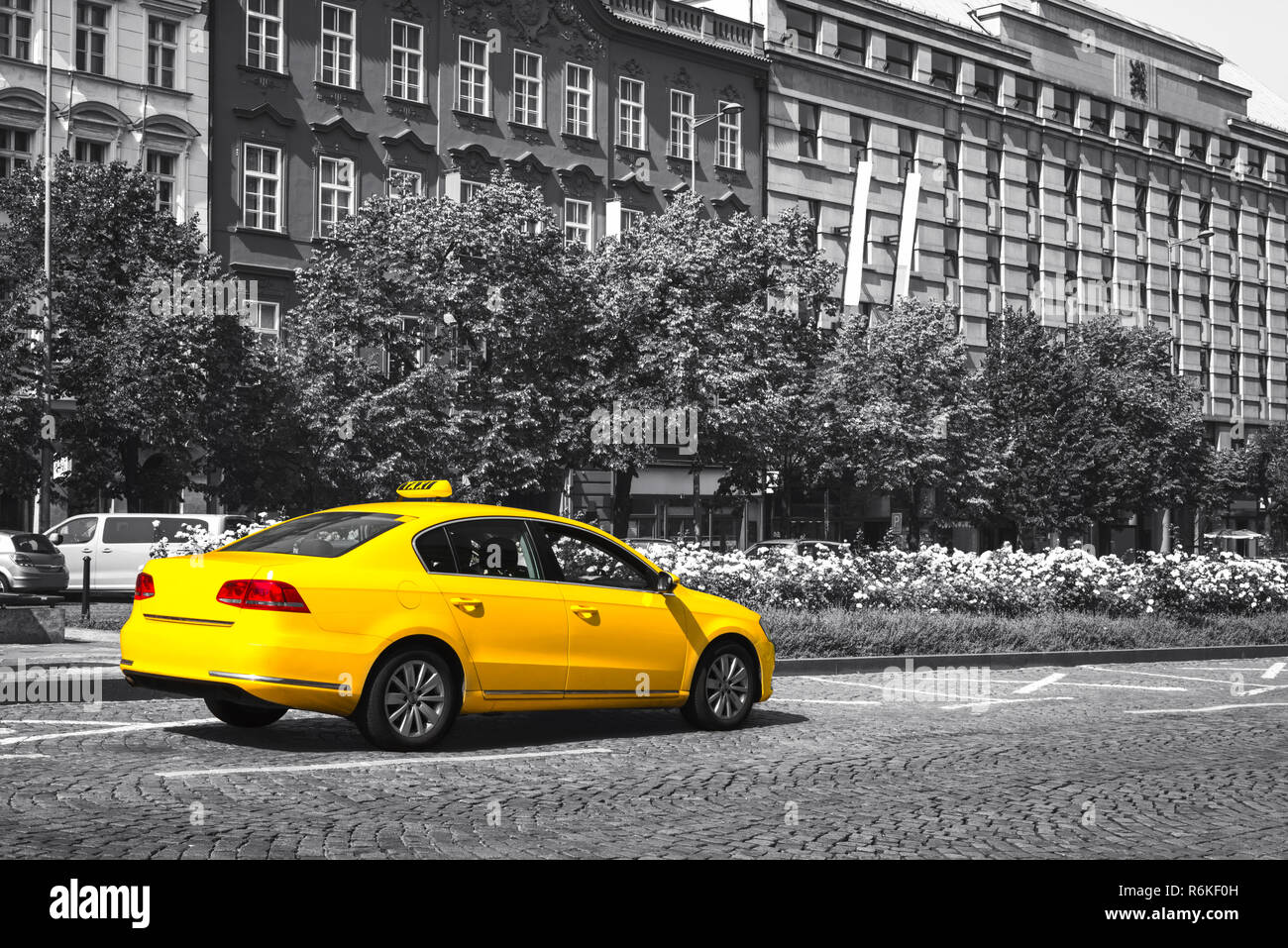 Yellow taxi parked on city street. Black and white. Selective color ...
