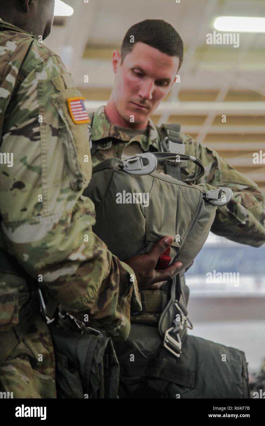 U.S. Army Paratrooper assists Sgt. Brian Raymond with his T11 reserve ...