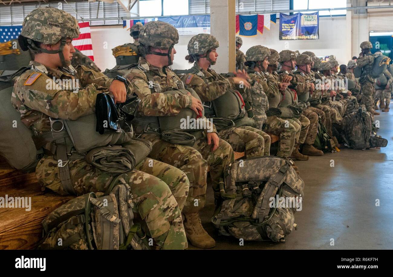 Paratroopers assigned to the 82nd Airborne Division wait to depart to ...