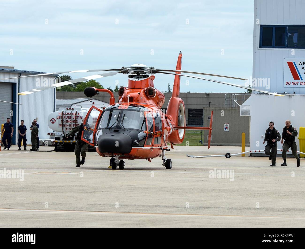 U.S. Coast Guard HH-65C Dolphin crew members from a U.S. Coast Guard ...