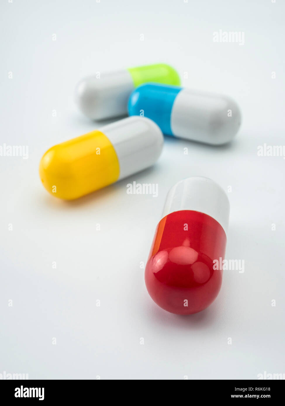 Several capsules of different color isolated on white background ...