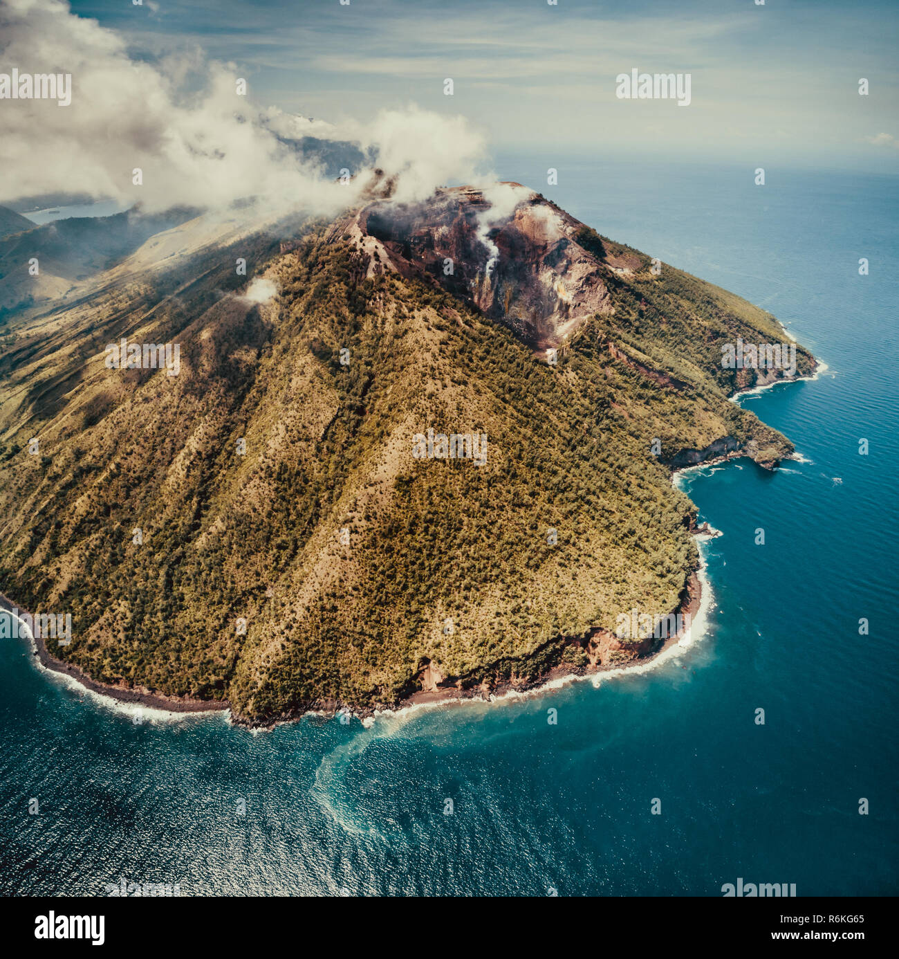 Fog over Indonesia volcano. Aerial drone shot. Amazing overview of ...