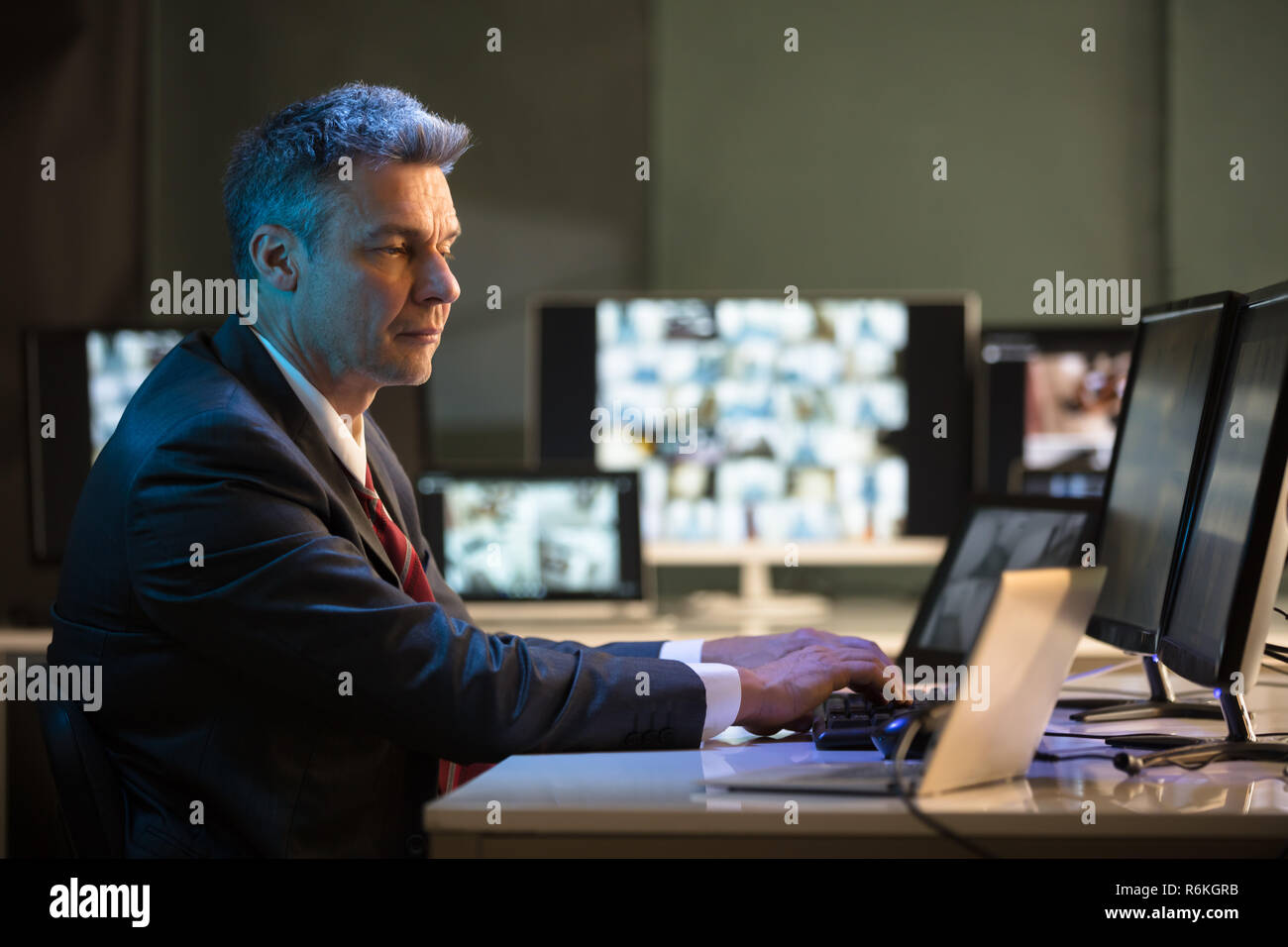 Businessman Looking At CCTV Camera Footage Stock Photo - Alamy