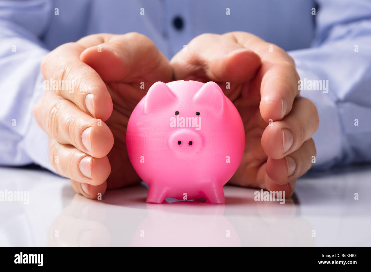 Human Hand Protecting Piggy Bank Stock Photo - Alamy