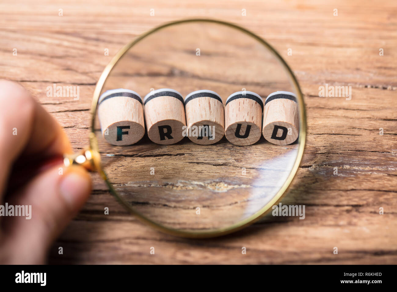 Person Examining Fraud Blocks Through Magnifying Glass Stock Photo - Alamy