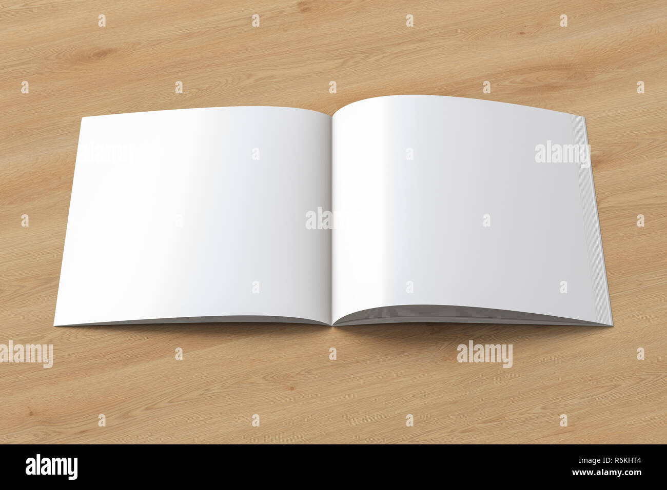 Open blank square booklet on wooden background with clipping path ...