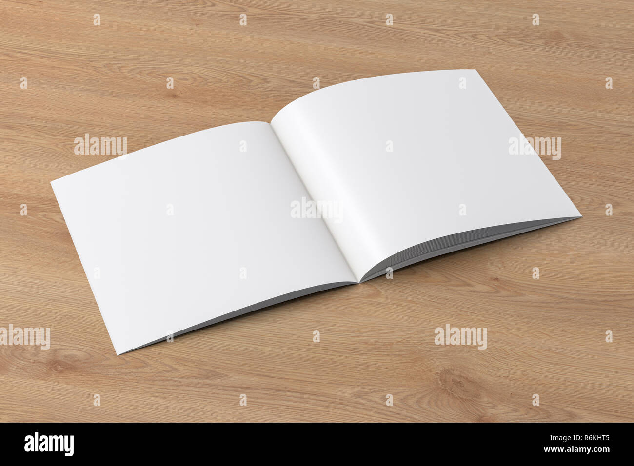 Open blank square booklet on wooden background with clipping path ...