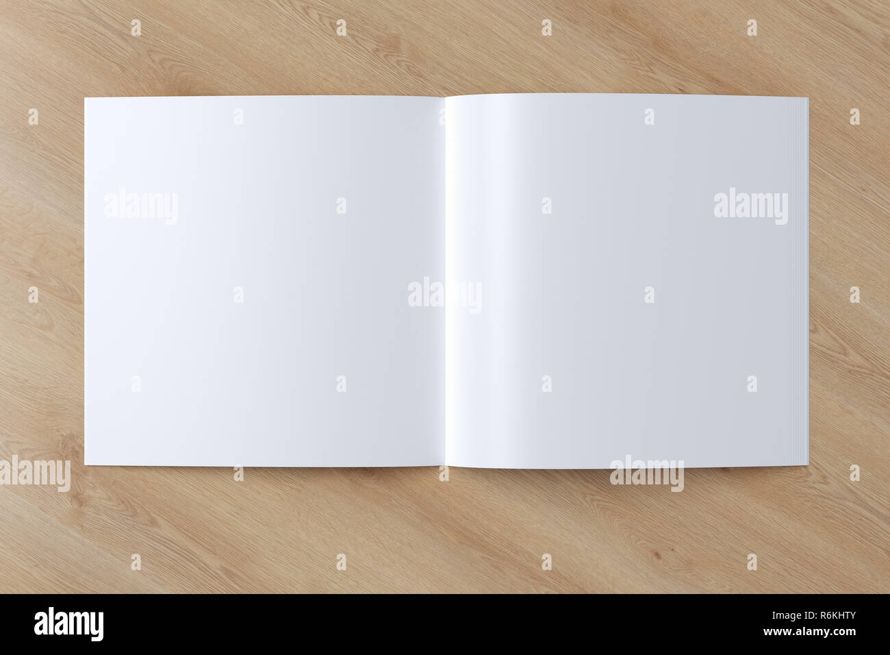 Open blank square booklet on wooden background with clipping path ...