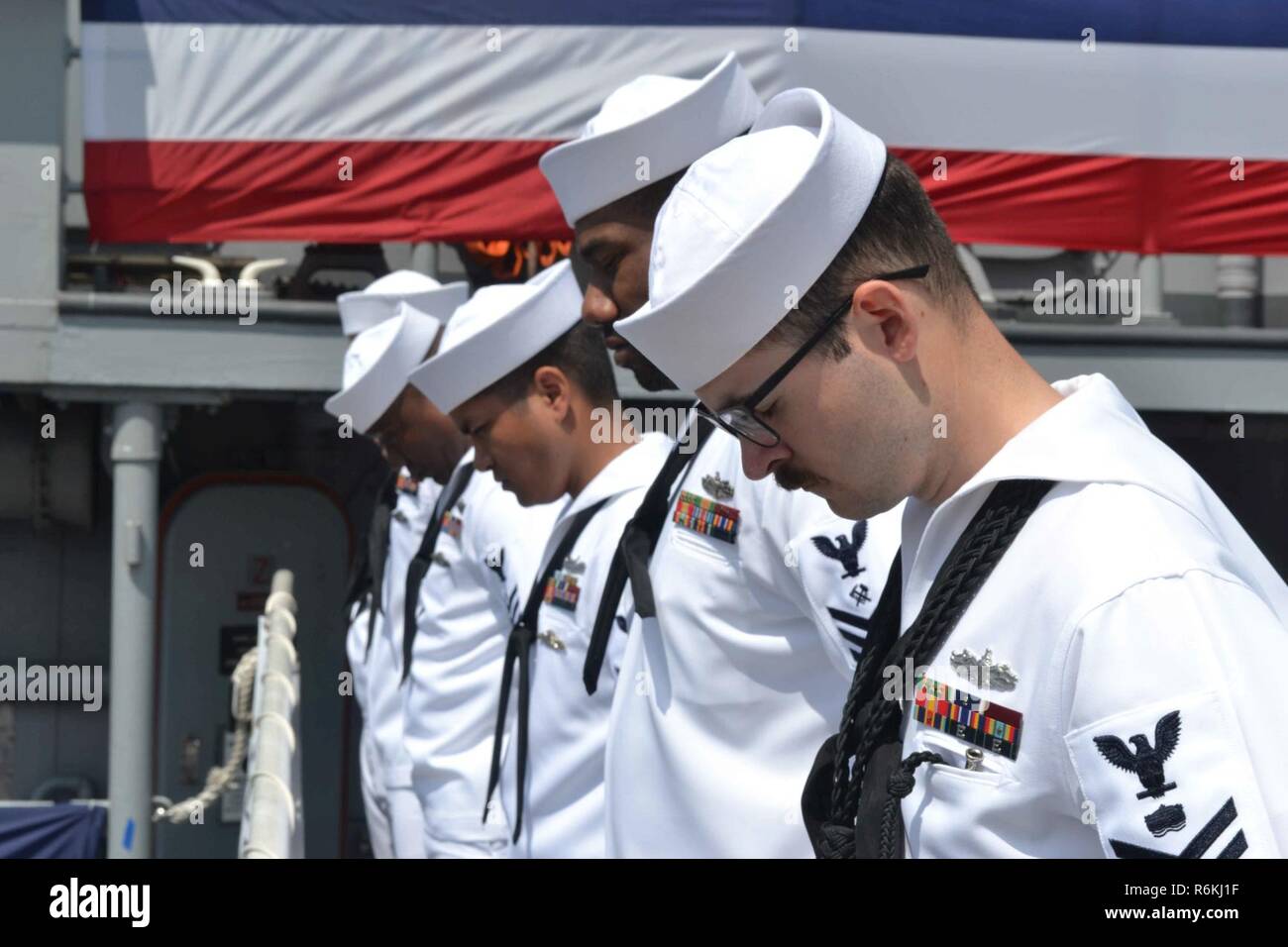 SASEBO, Japan (May 25, 2017) Sailors bow their head during the ...