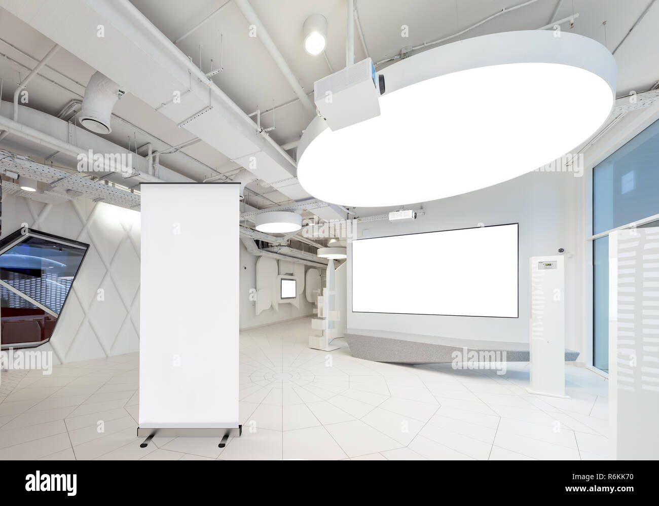 Blank roll up banner stand and info display in office lobby interior ...