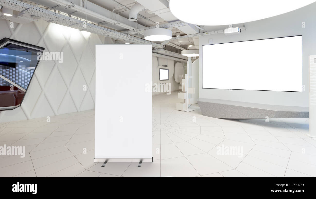 Blank roll up banner stand and info display in office lobby interior ...