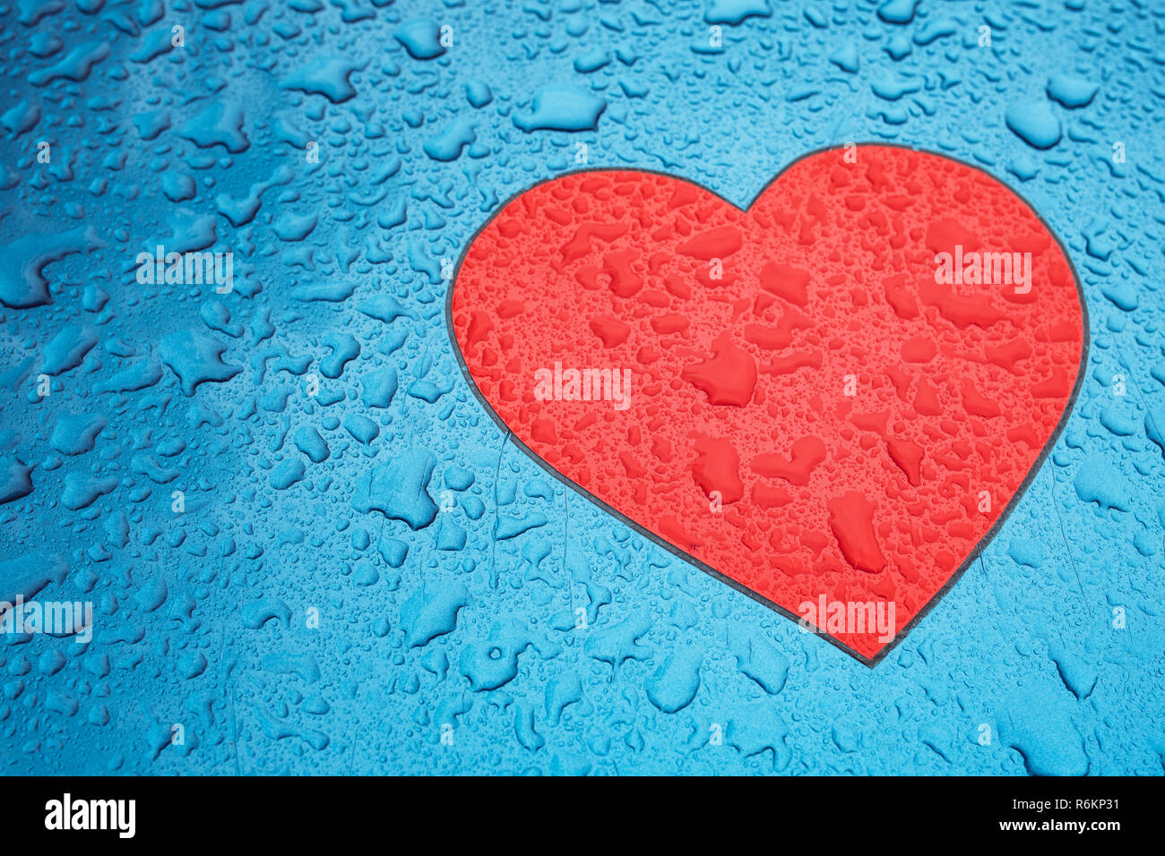 Heart shape symbol and raindrops on metal surface, love and romance ...