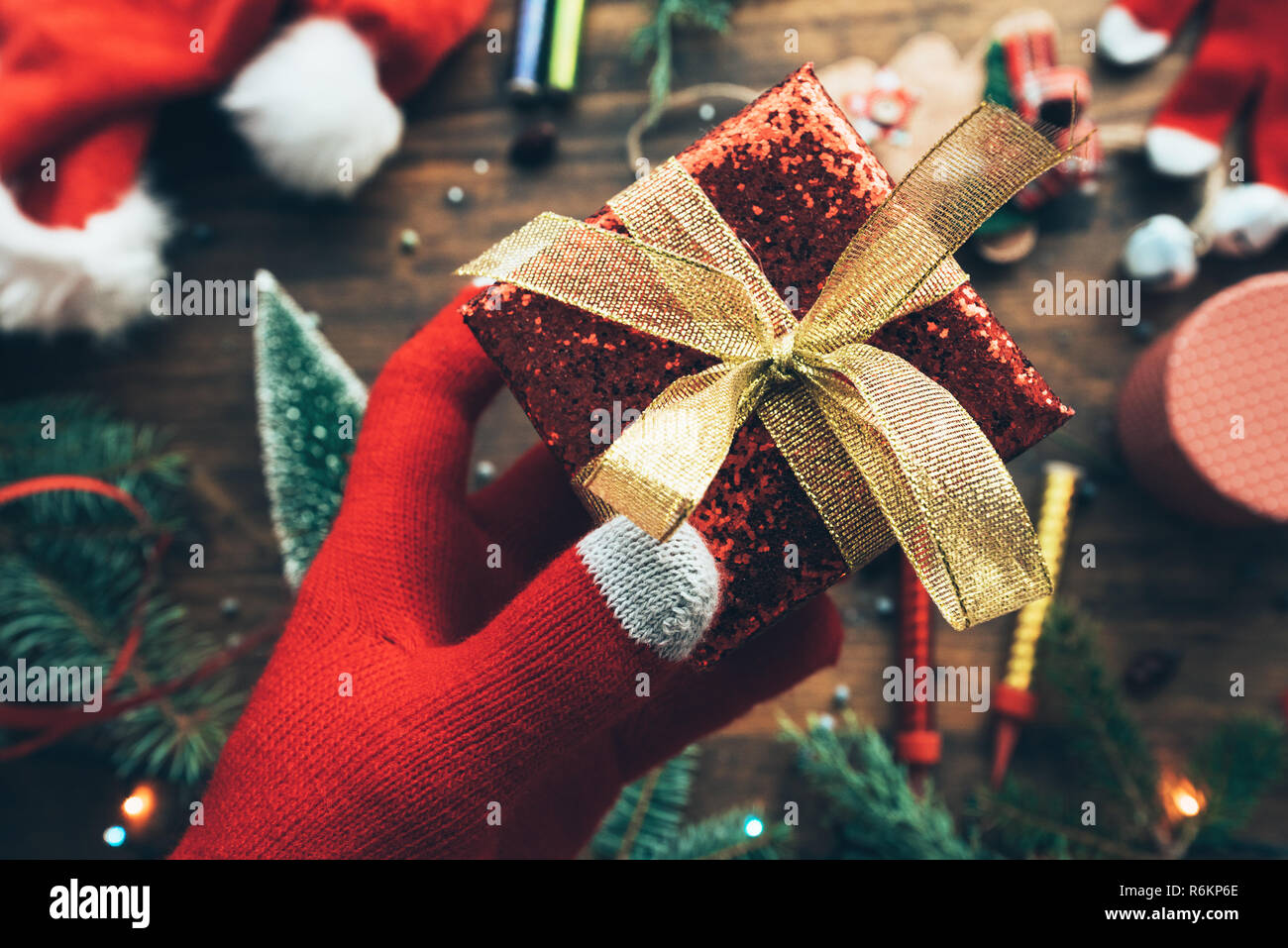 Hand offering Christmas gift wrapped in a box for cheerful holidays ...