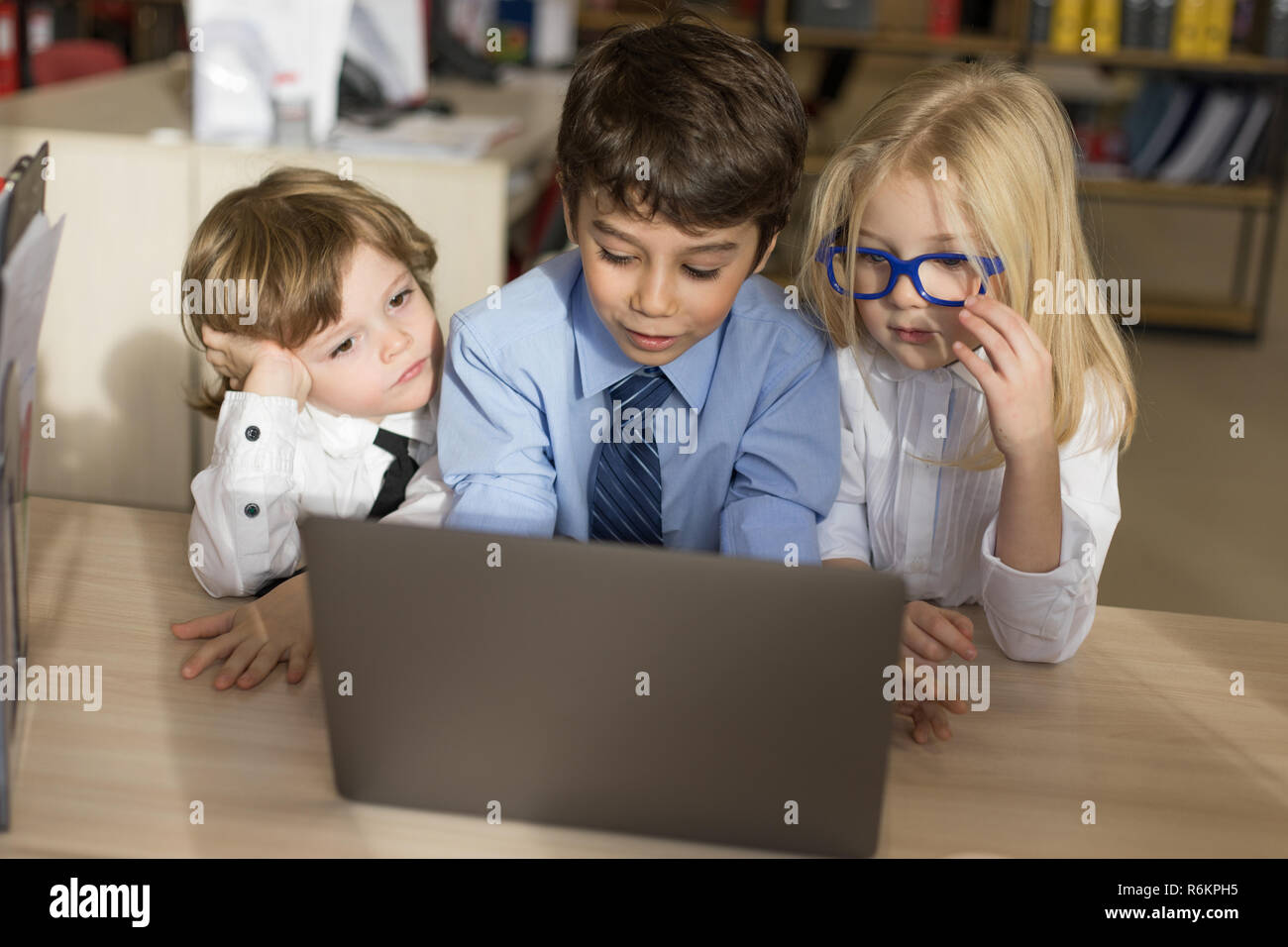 Little children businessmen work in the office and use a laptop Stock ...