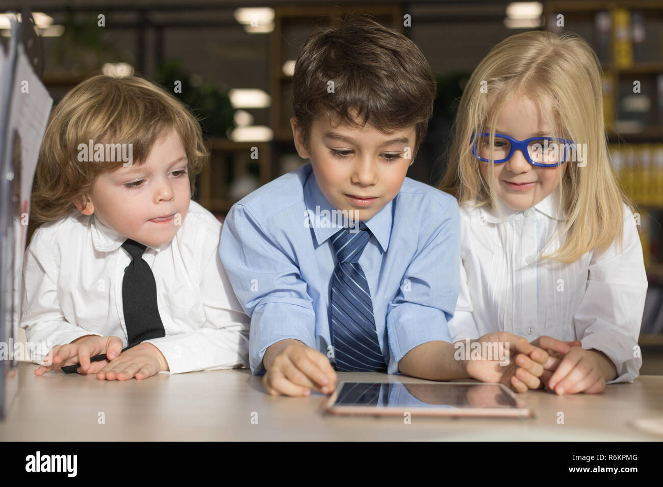 Small businessmen sit at the table in the office and use the tablet ...