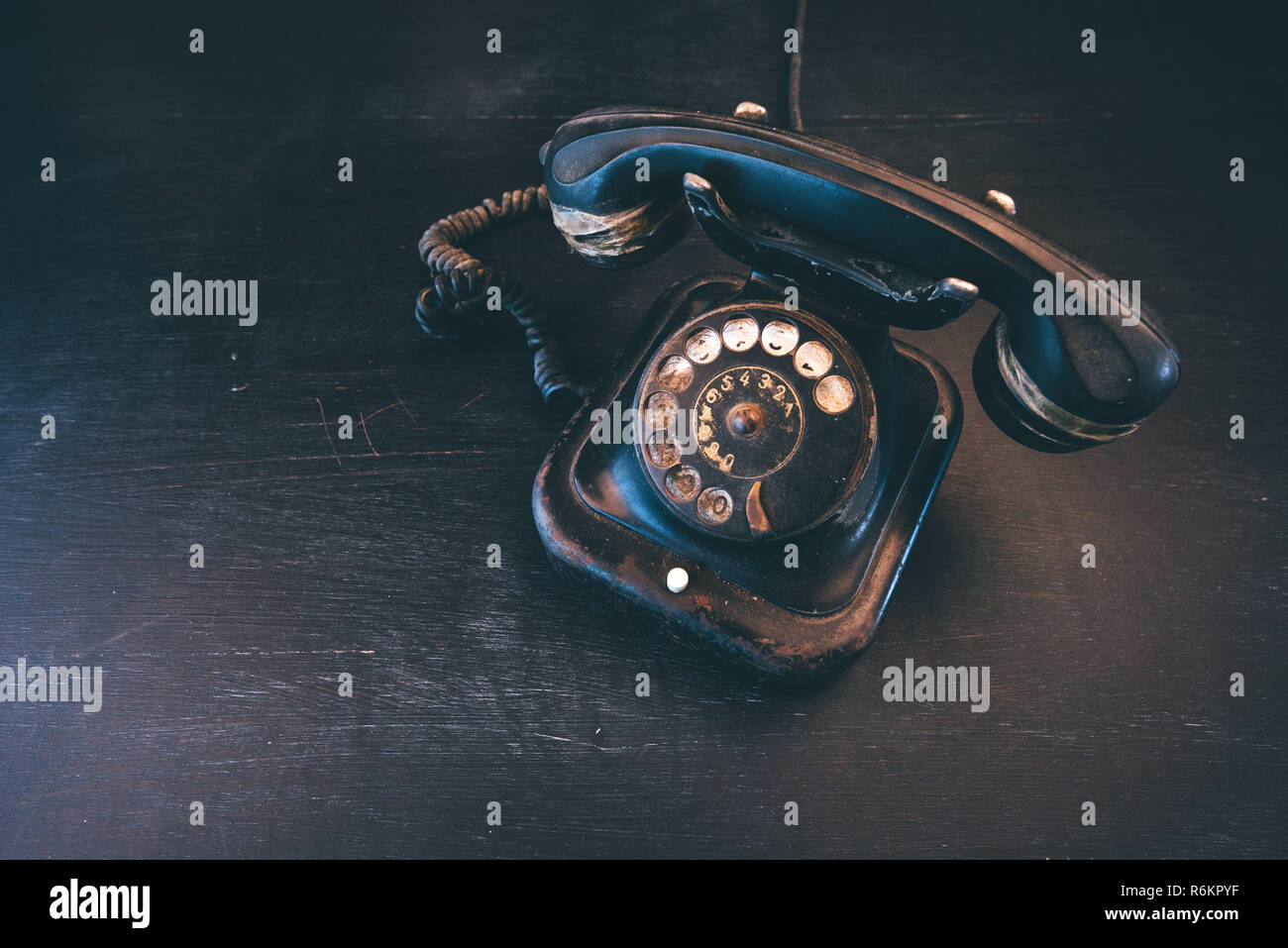 Black vintage landline telephone, old and weathered. Broken ...