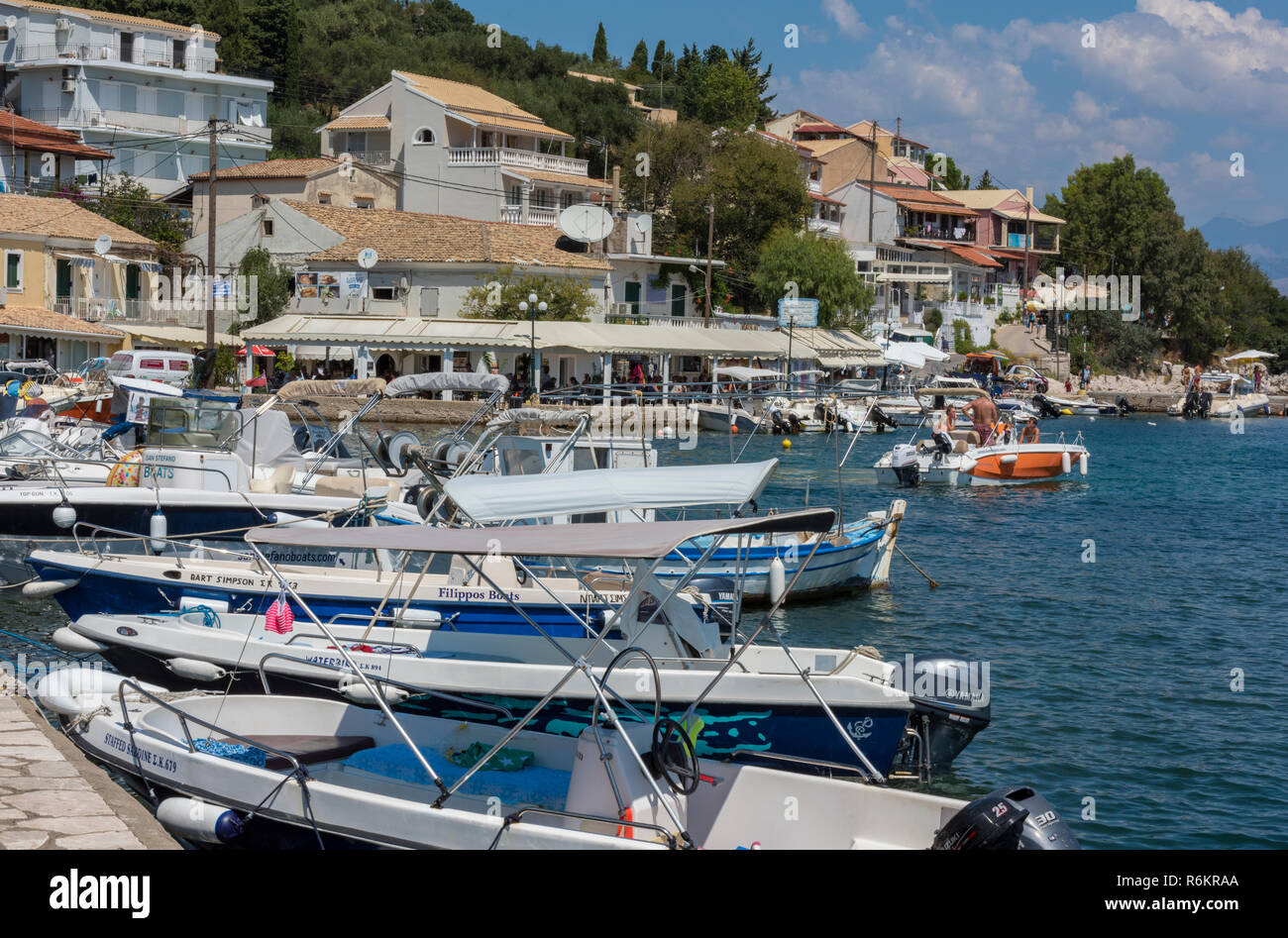 the corfu fishing village of kassiopi in Greece with small fishing ...