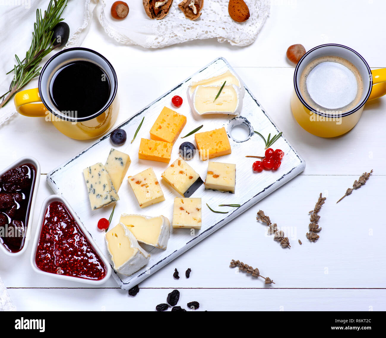 Various types of cheese with tartar and clove jam and black coffee ...
