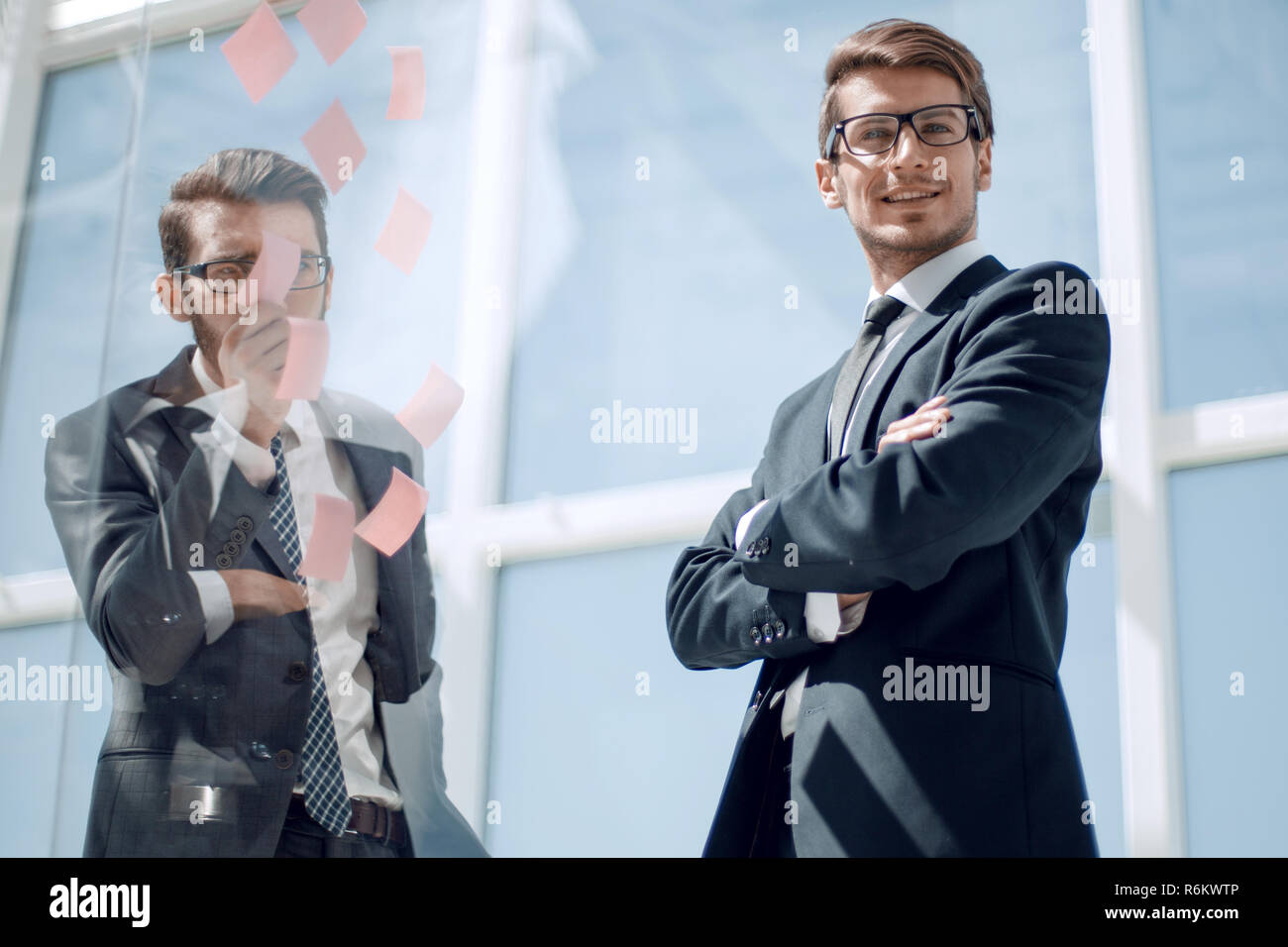 employee reading the stickers pasted on the glass wall Stock Photo - Alamy