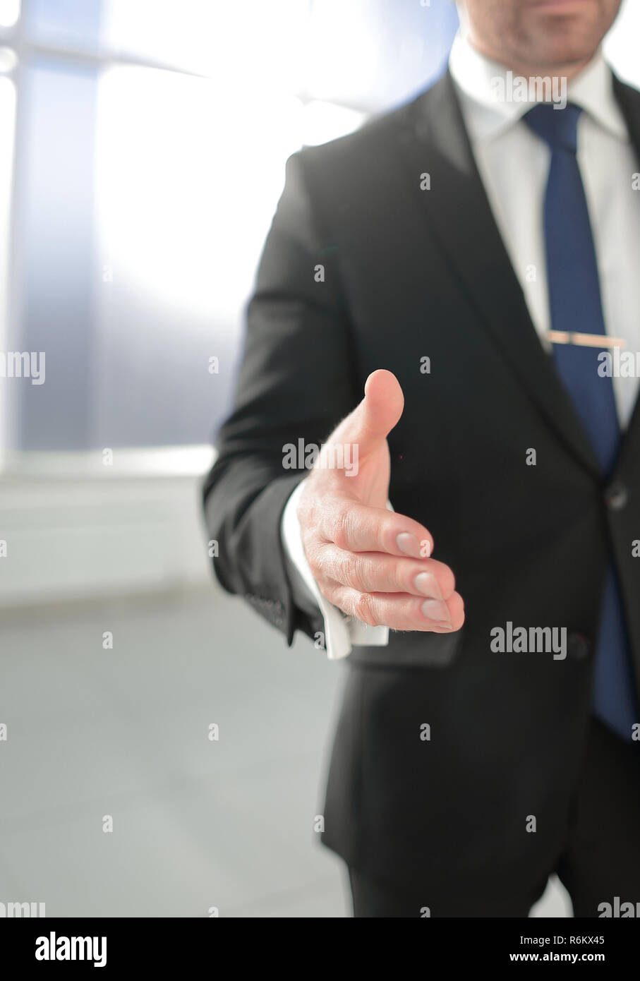 businessman holding out his hand for a handshake Stock Photo - Alamy