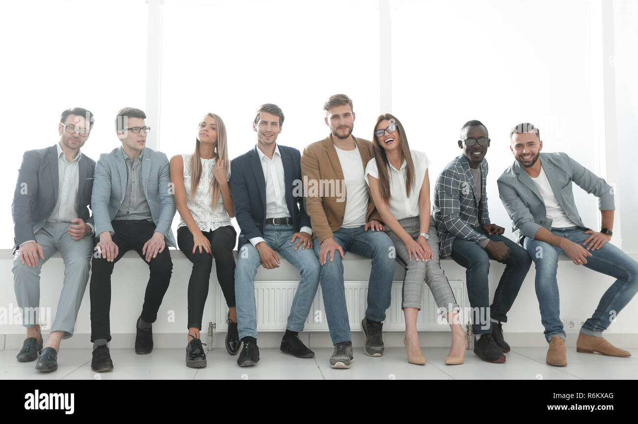 young people are waiting for an interview, sitting in the office lobby ...