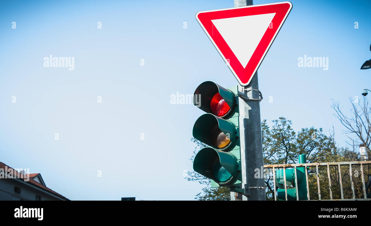 tricolor traffic light with a triangle sign giving way in Italy Stock ...