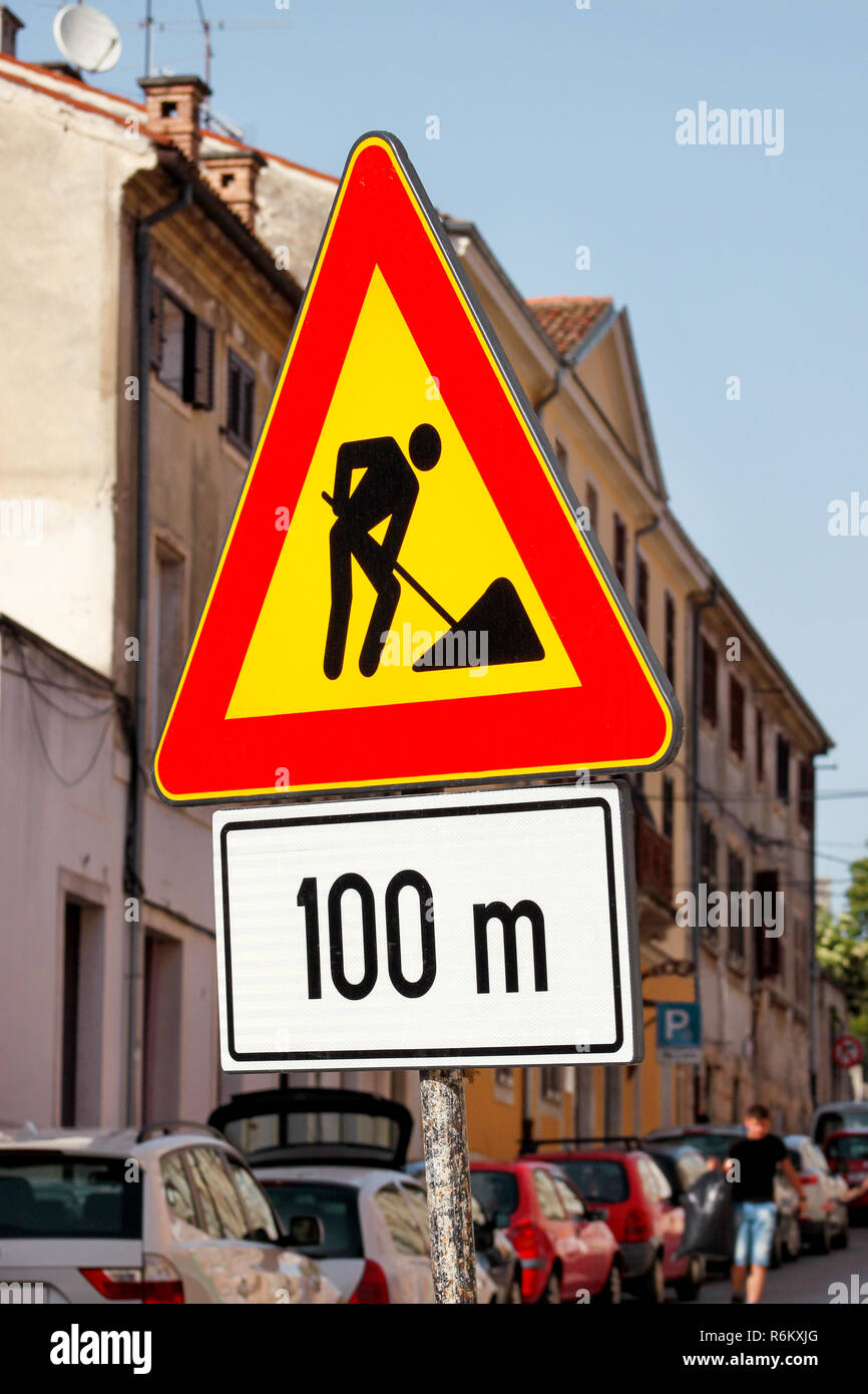 Road works sign for construction works in city street. Road under ...