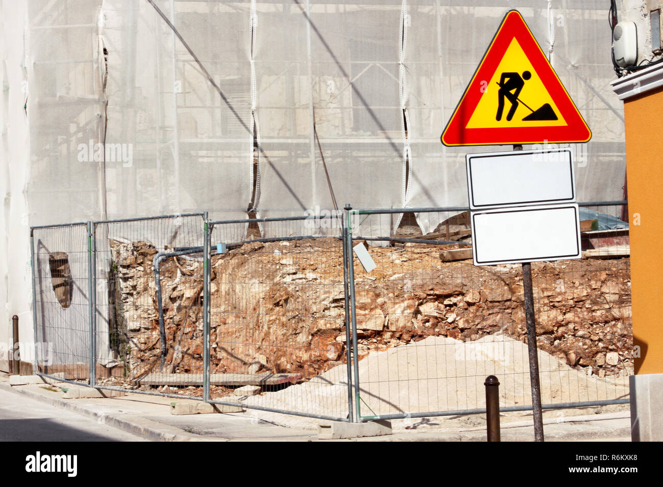 Road construction work and sign at a construction site. Warning sign ...
