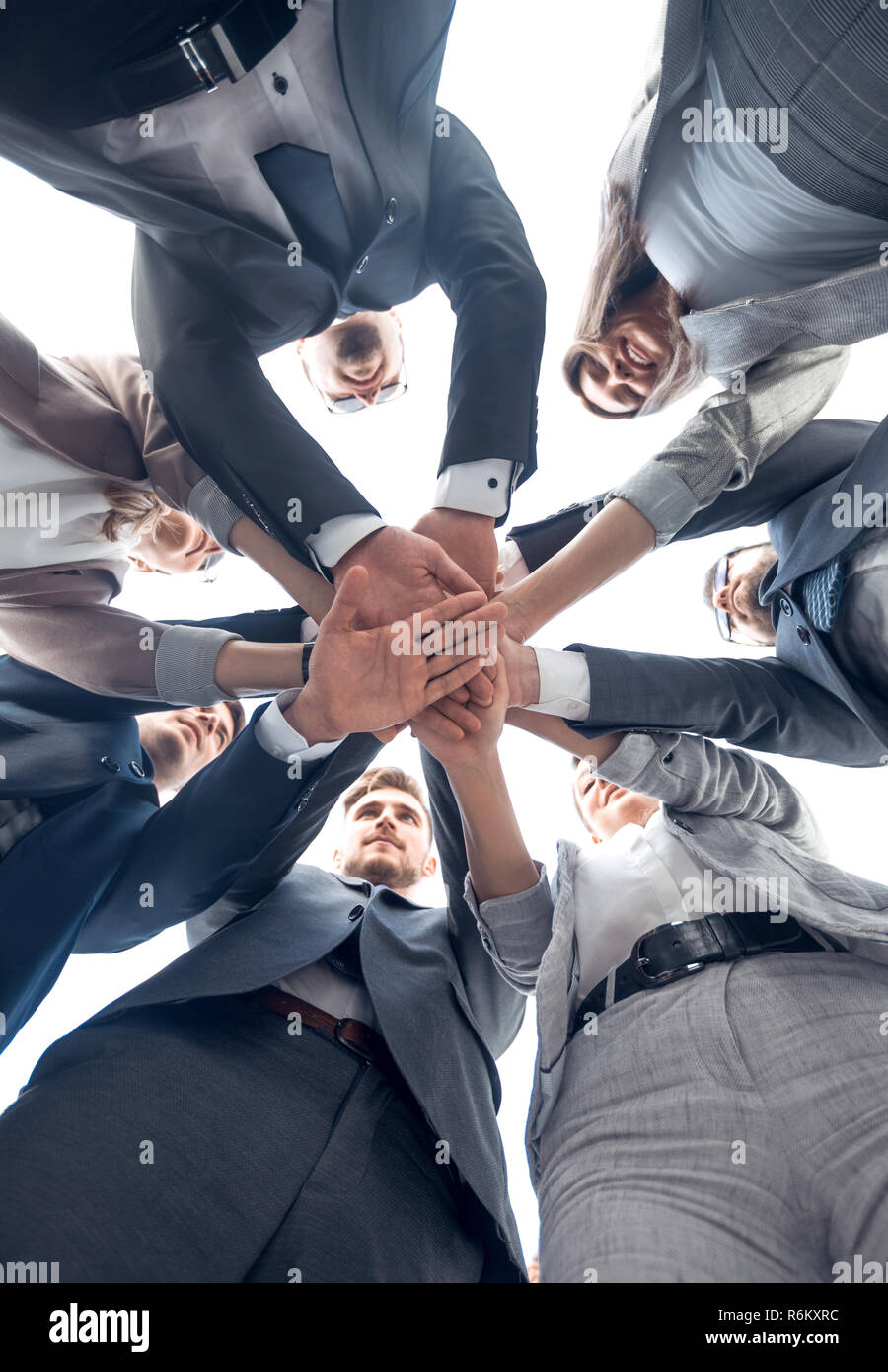bottom view. business team showing unity with their hands together ...