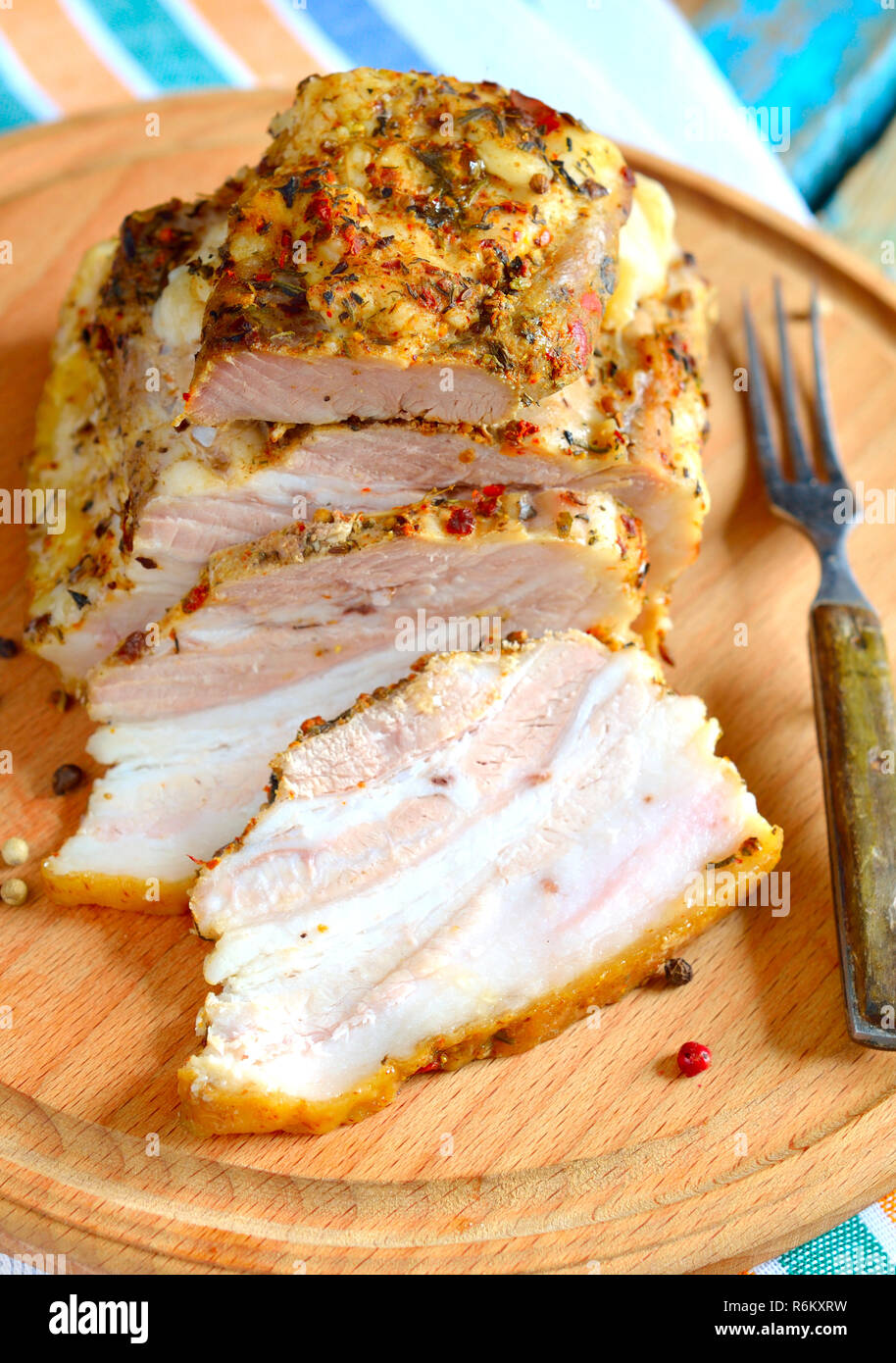 Baked pork on round board Stock Photo - Alamy