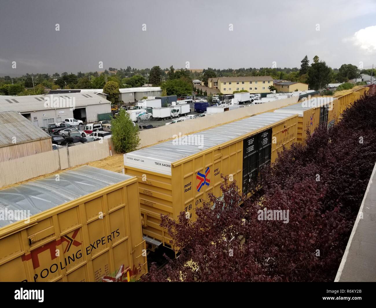 Aerial view of a freight train passing through Livermore, California on ...