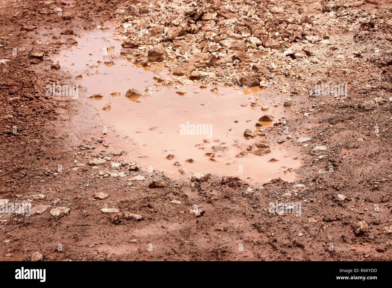 Water paddle on street after falling rain. Way after rain. Dirty puddle ...