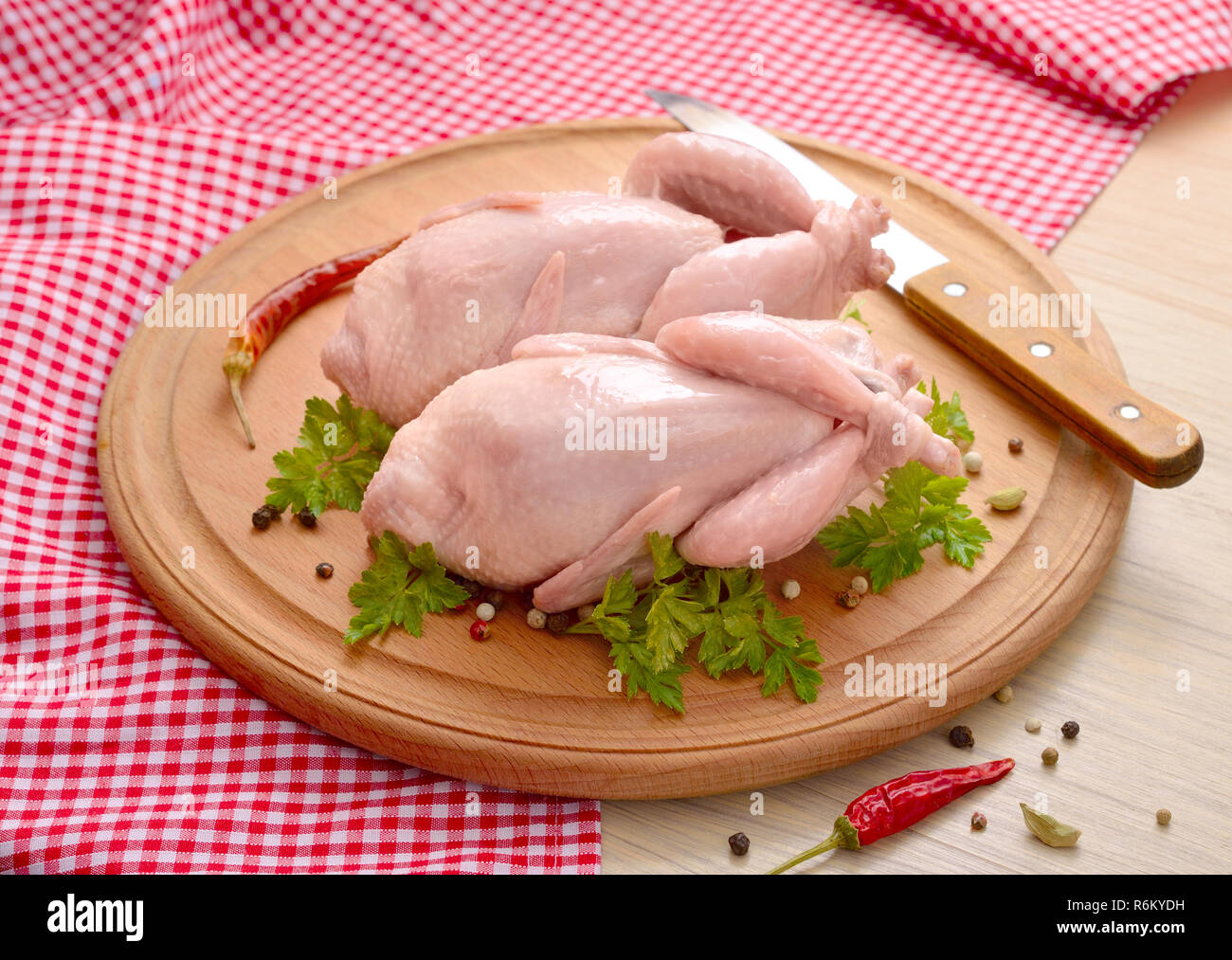 Quail meat on the round board Stock Photo - Alamy
