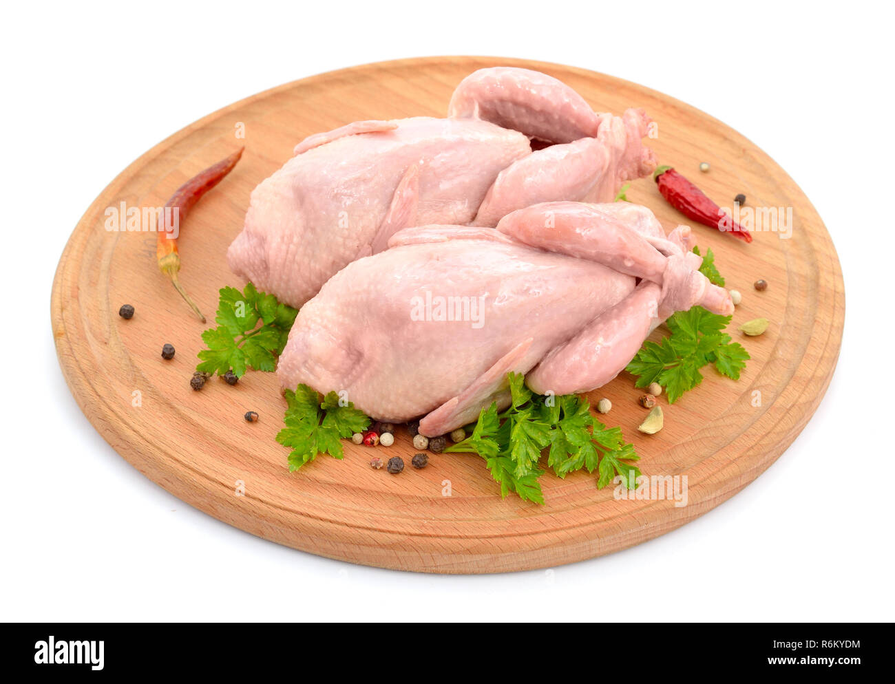 Quail meat on the round board. Isolated on white background Stock Photo ...
