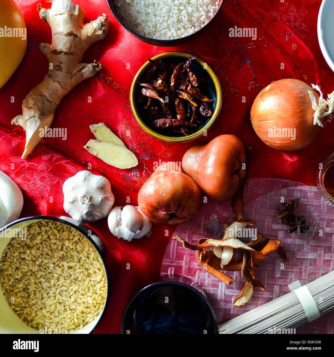 An assortment of Chinese and East Asian ingredients on a red silk ...