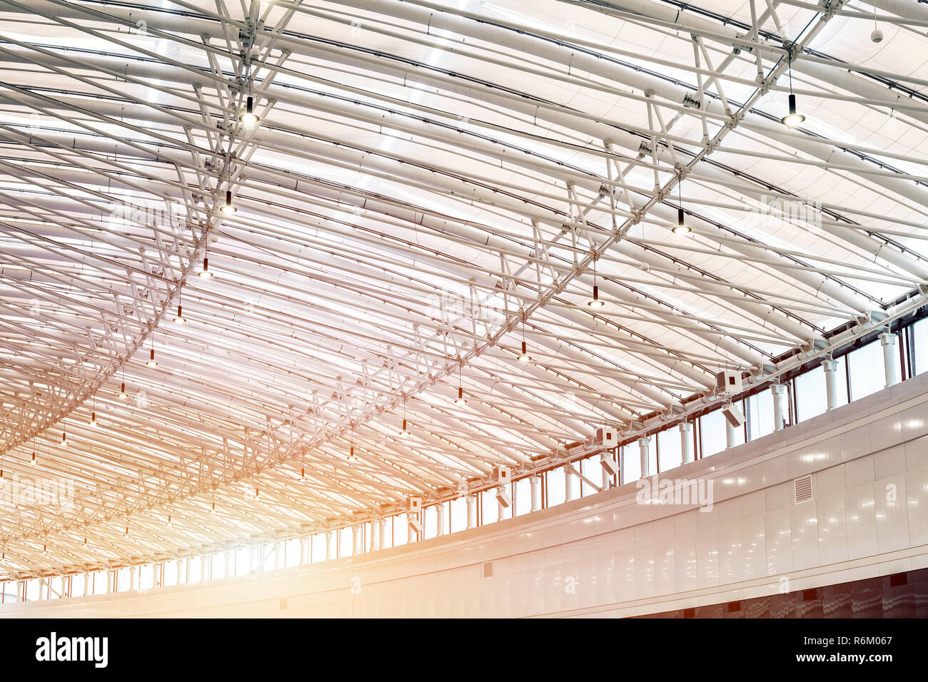 Curved big shoppimg mall roof indoors. Modern metal and glass ceiling ...