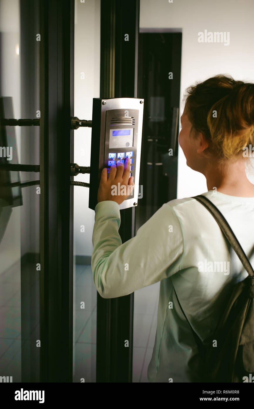 young blond teenager schoolgirl dials the code for a call over the ...