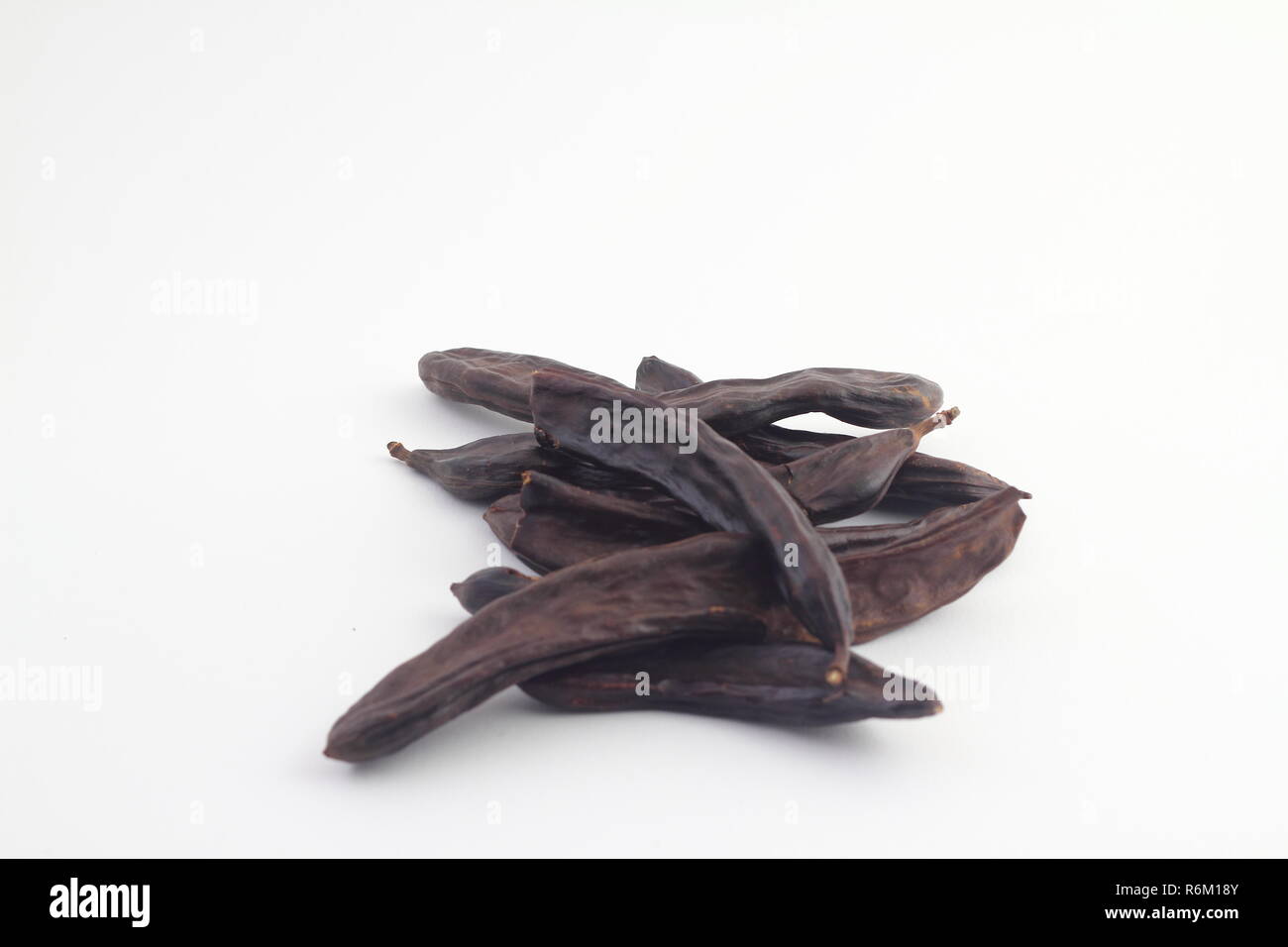Carob on white background. Organic carob pods with seeds Stock Photo ...