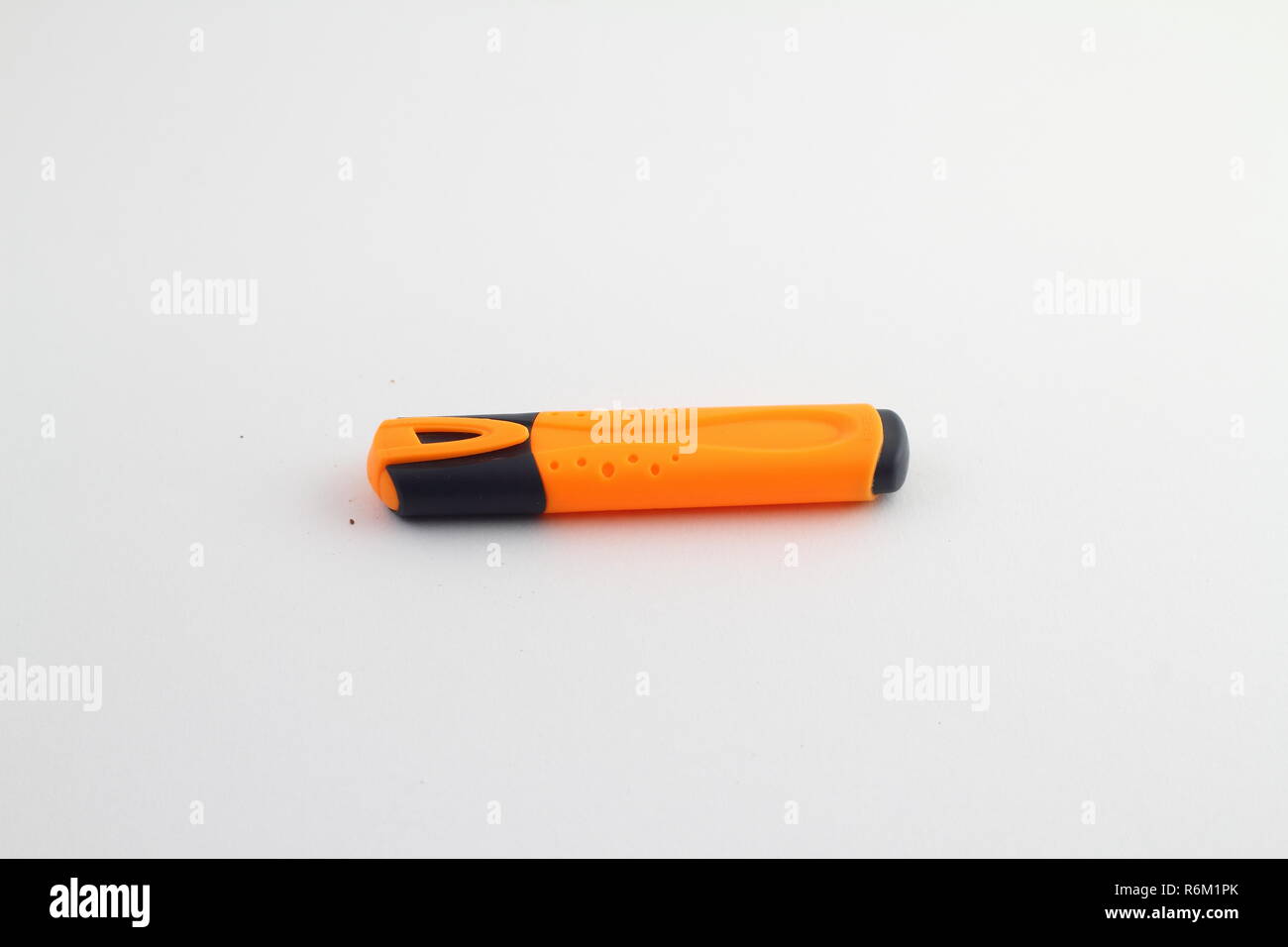 Orange marker on a white background Stock Photo - Alamy