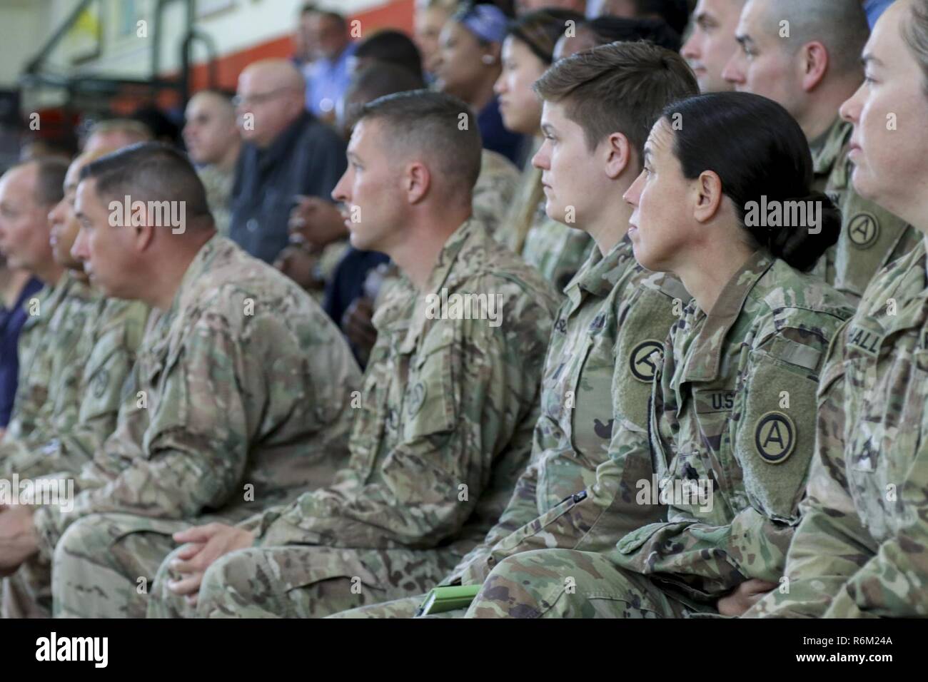 Staff members of USARCENT located at Camp Arifjan, Kuwait, listen to ...